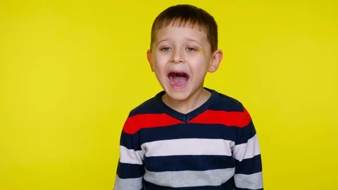 Little child boy screaming on a yellow b... | Stock Video | Pond5
