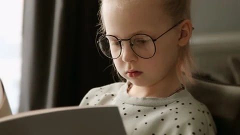 Little child clever girl reading a book ... | Stock Video | Pond5