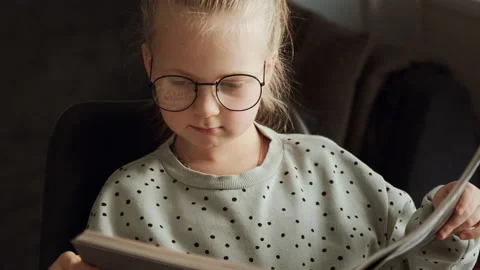 Little child clever girl reading a book ... | Stock Video | Pond5