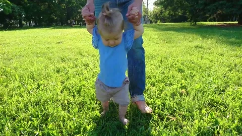 Little child does her first steps with m... | Stock Video | Pond5