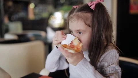 Little child girl eating chewing a piece... | Stock Video | Pond5