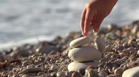 Little child hand taking off stones from... | Stock Video | Pond5