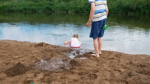 Little children play in the river in the... | Stock Video | Pond5
