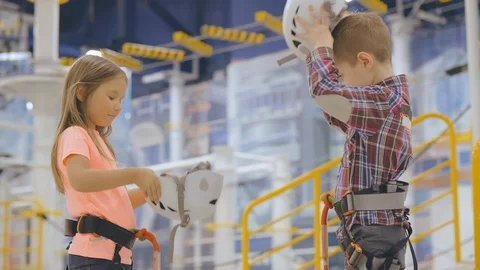 Little children putting on safety equipm... | Stock Video | Pond5