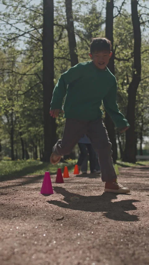 Little Children Running Between Cones in... | Stock Video | Pond5