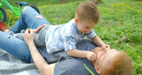 Little cute boy is pulling the cheeks of... | Stock Video | Pond5