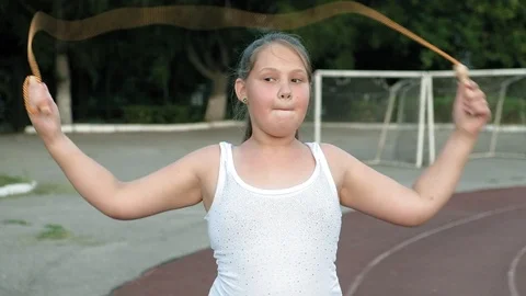 Little fat girl jumping rope in the stad... | Stock Video | Pond5