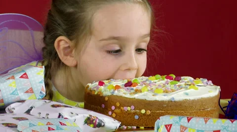 Little Girl Biting into a Birthday Cake | Stock Video | Pond5