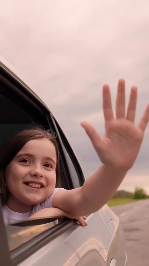 Little girl child waving from car window... | Stock Video | Pond5