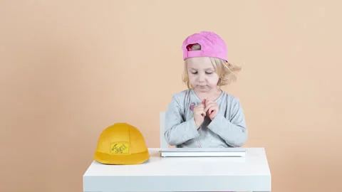 A little girl civil engineer is typing o... | Stock Video | Pond5