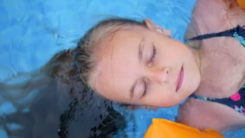 Little girl with closed eyes relaxing on... | Stock Video | Pond5