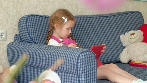 Little girl coloring on a tablet | Stock Video | Pond5