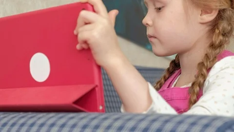 Little girl coloring on a tablet | Stock Video | Pond5