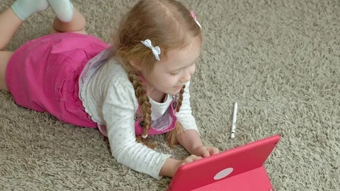 Little girl coloring on a tablet | Stock Video | Pond5
