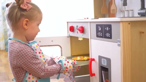 A little girl cooks pizza in the childre... | Stock Video | Pond5