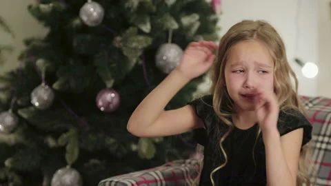 A little girl crying near the tree. The ... | Stock Video | Pond5