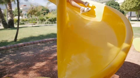Little girl on curved slide, slow motion | Stock Video | Pond5