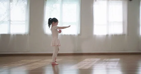 Little girl dancing alone in a studio | Stock Video | Pond5
