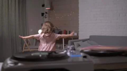Little girl dancing at home to the sound... | Stock Video | Pond5