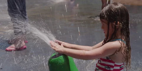 Little girl deflecting the water at a wa... | Stock Video | Pond5