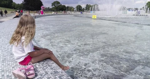 A little girl dips her bare feet in the ... | Stock Video | Pond5