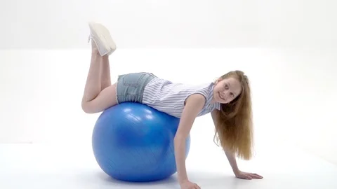 little girl doing exercises on a big bal... | Stock Video | Pond5