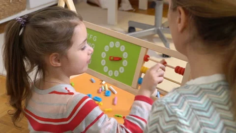 Little girl doing math exercises with he... | Stock Video | Pond5