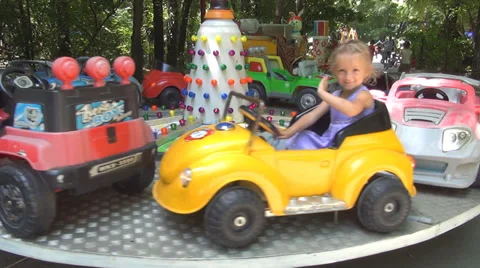 Little Girl Driving a Car at Playground ... | Stock Video | Pond5