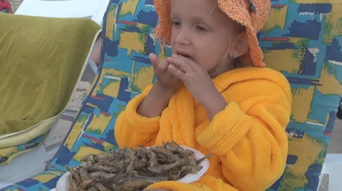 Little Girl Eating Fried Fish with Lemon... | Stock Video | Pond5