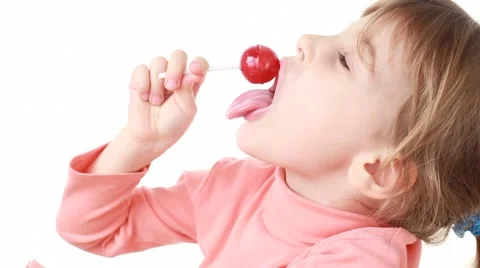 little girl eating lollipop, then looks ... | Stock Video | Pond5