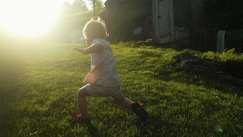 Little Girl Falling Down When Running on... | Stock Video | Pond5
