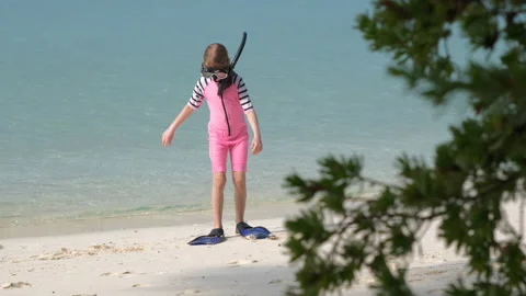 Little girl in flippers walking on the b... | Stock Video | Pond5