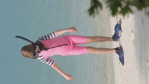 Little girl in flippers walking | Stock Video | Pond5