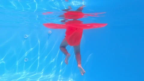 Little girl floats on an inflatable ring... | Stock Video | Pond5