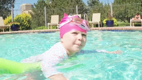 Little girl having fun with swim noodle ... | Stock Video | Pond5