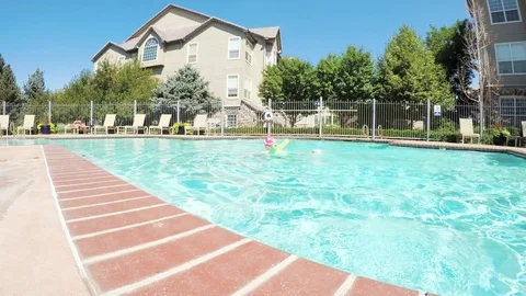 Little girl having fun with swim noodle ... | Stock Video | Pond5