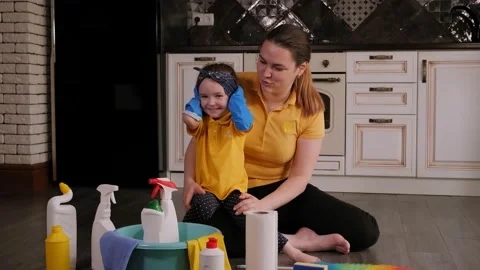 A little girl helps her mother clean the... | Stock Video | Pond5