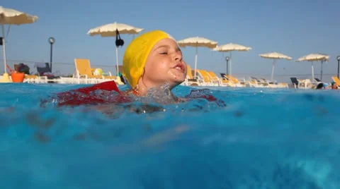 Little girl with inflatable arm ruffles ... | Stock Video | Pond5