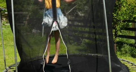 A little girl jumping up and down on her... | Stock Video | Pond5