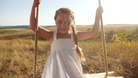 little girl kid swinging on a wooden swi... | Stock Video | Pond5