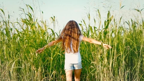 A little girl with long flowing hair run... | Stock Video | Pond5