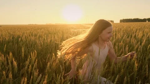 little girl with long hair runs across t... | Stock Video | Pond5