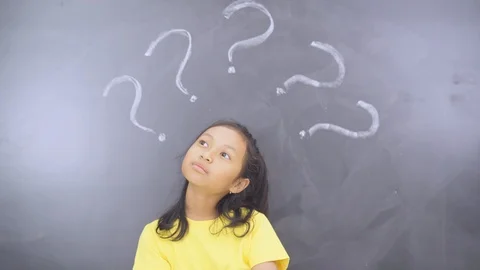 Little girl looking at question marks ov... | Stock Video | Pond5