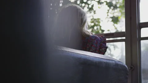 Little Girl Looks Out Window Of School B... | Stock Video | Pond5