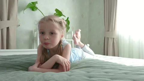 Little girl lying on the bed. Concept of... | Stock Video | Pond5