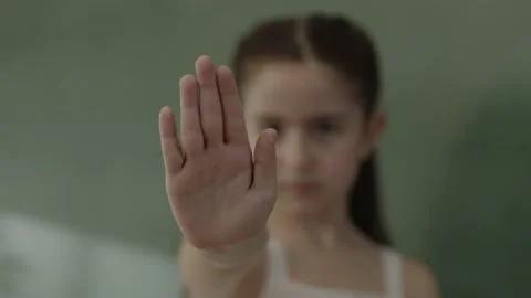 Little girl makes a stop sign with her h... | Stock Video | Pond5