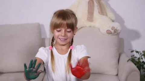 Little girl making hand-prints with pain... | Stock Video | Pond5