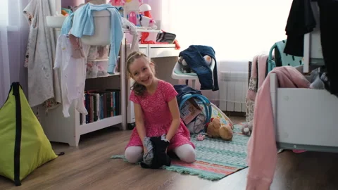 Little girl making a mess by throwing cl... | Stock Video | Pond5