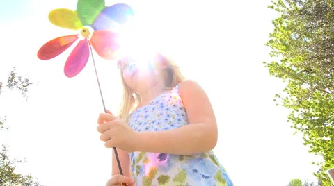 Little Girl Outdoors with Toy Pin Wheel | Stock Video | Pond5