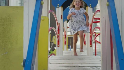 Little Girl On The Playground. Girl Runs... | Stock Video | Pond5